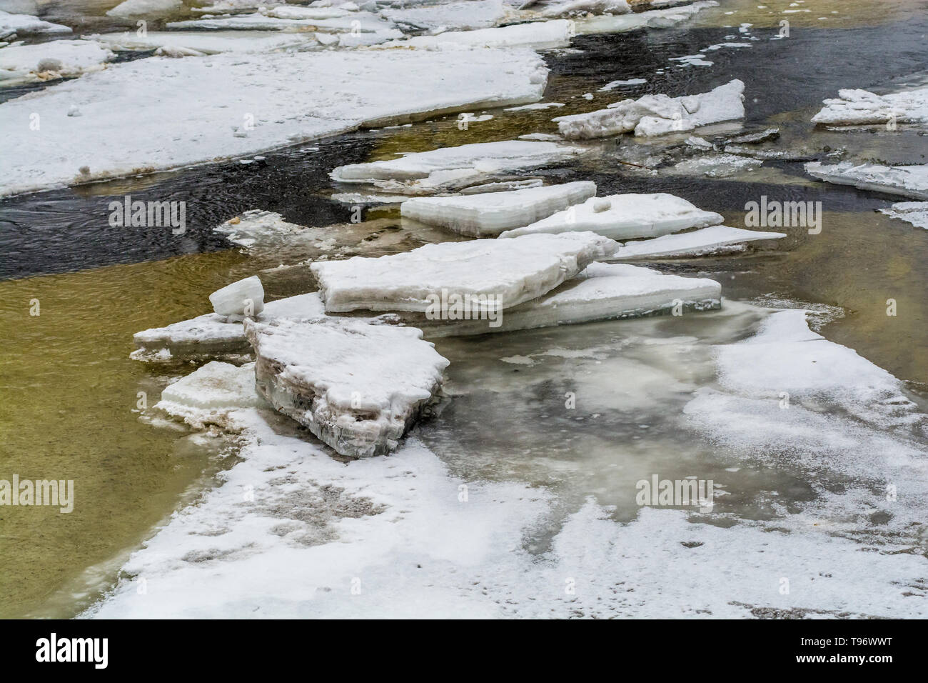Ice on frozen river Stock Photo - Alamy