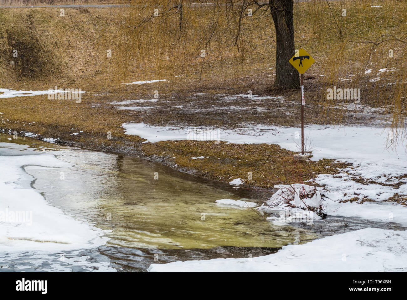Canoe crossing sign on frozen stream Stock Photo - Alamy