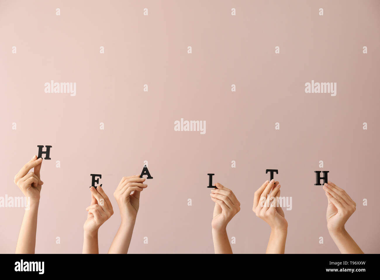 Female hands with letters forming word HEALTH on light background Stock ...