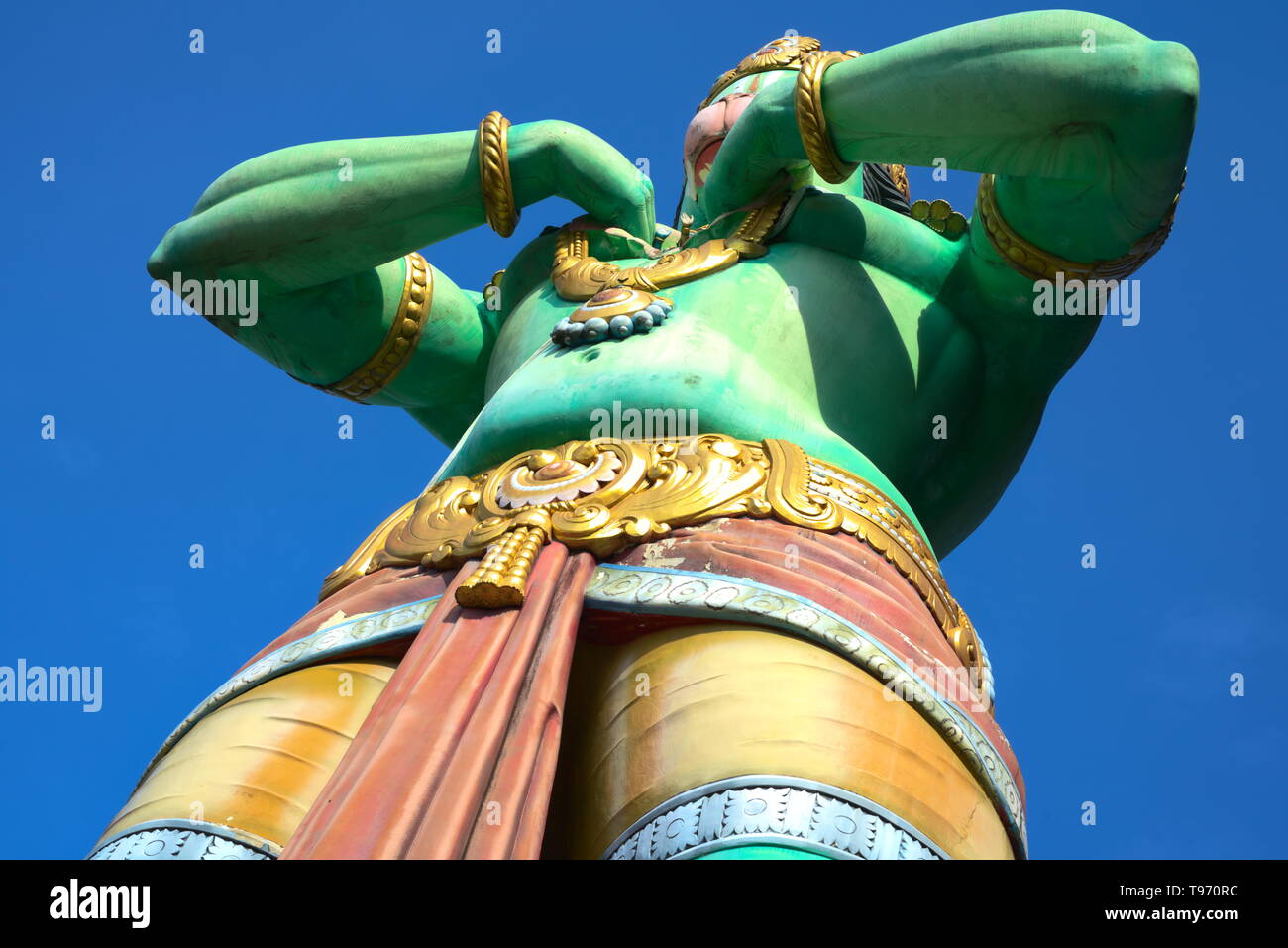under hanuman hindu god statue in batu caves malaysia Stock Photo - Alamy