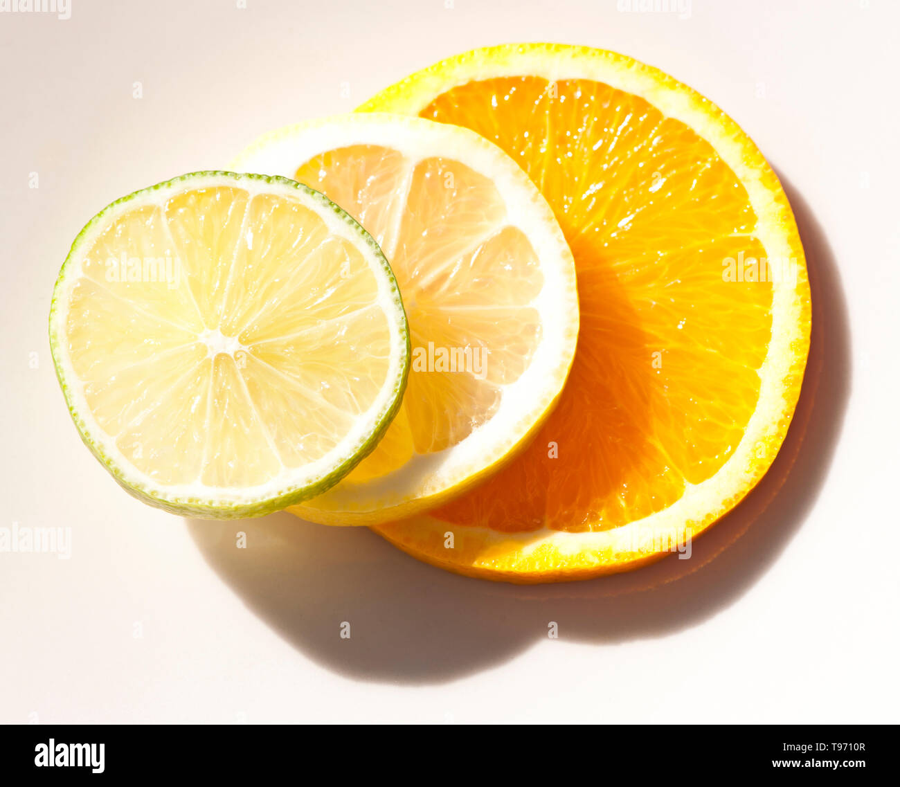 Sliced citrus fruits in the sunshine Stock Photo - Alamy