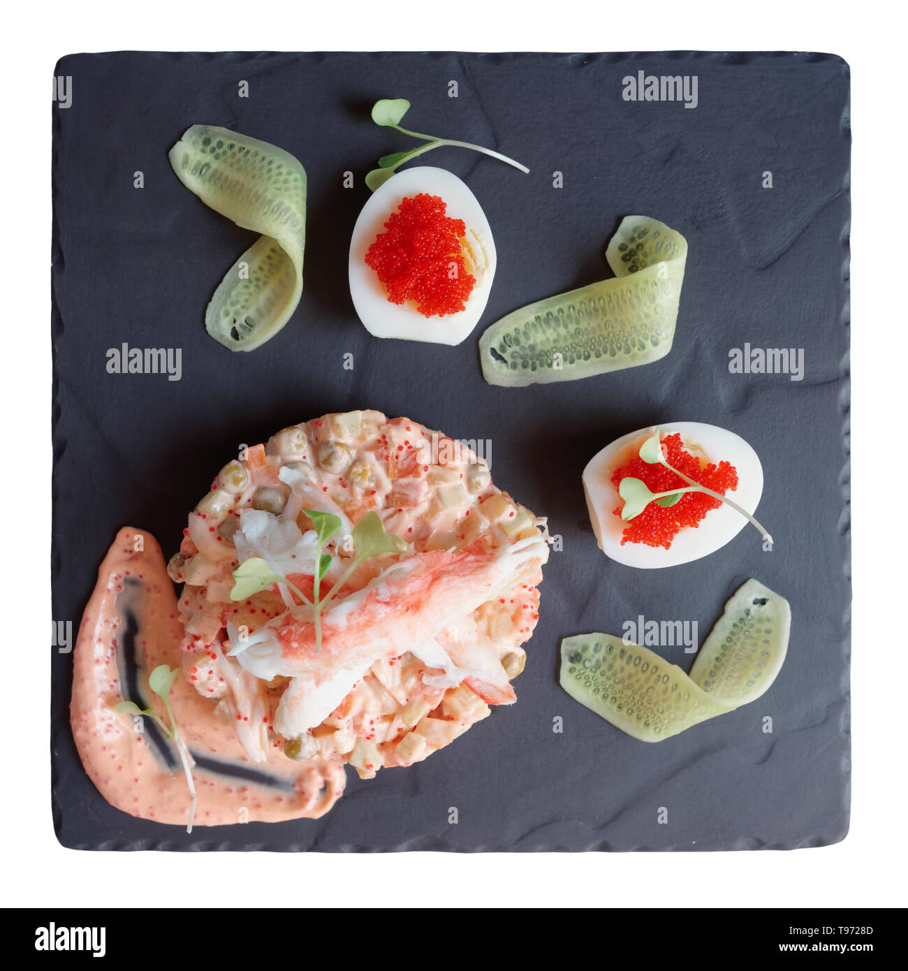 Gourmet appetizer with tobico fish roe and vegetables isolated on white ...