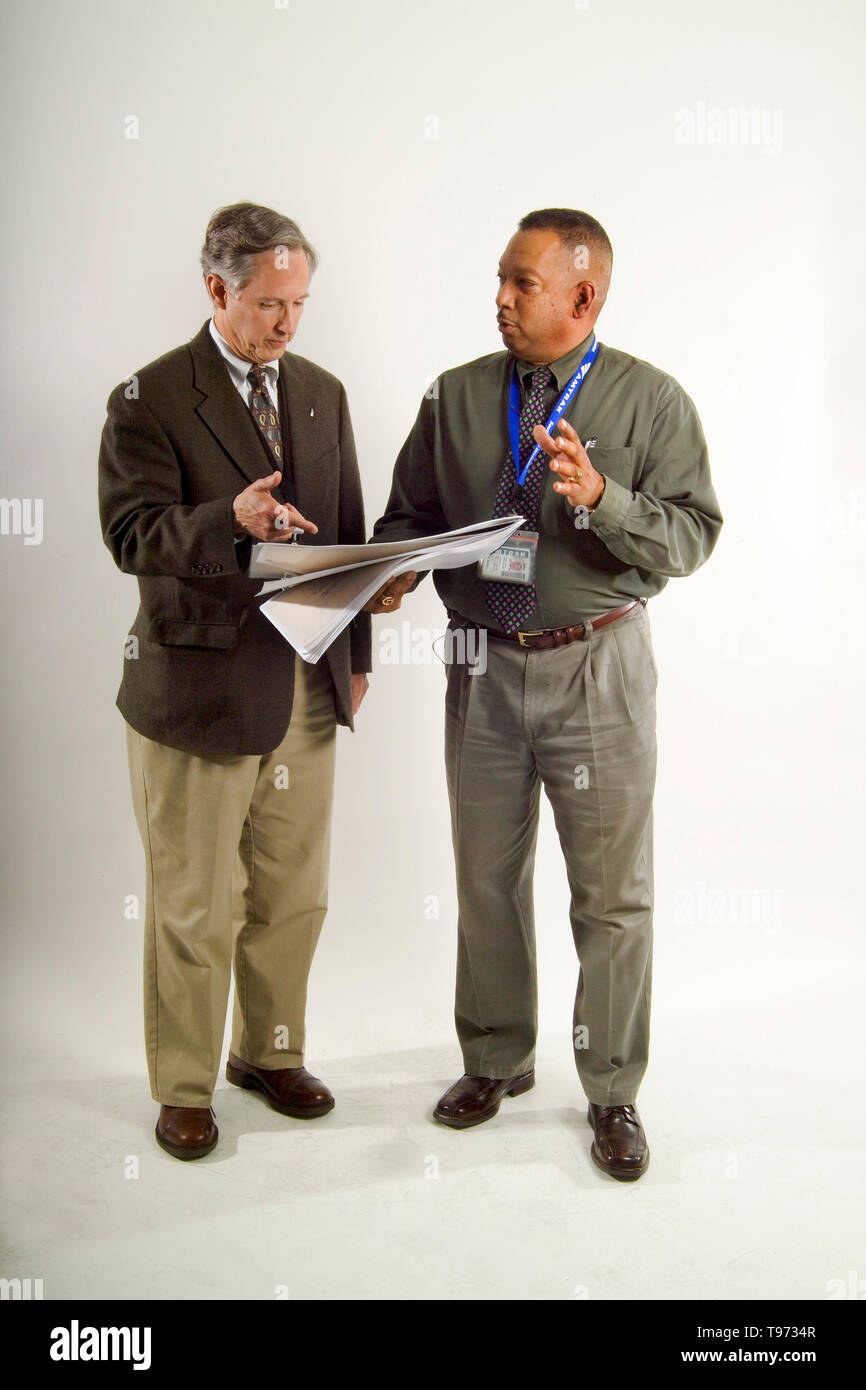 A railroad safety officer and his supervisor confer over a computer ...