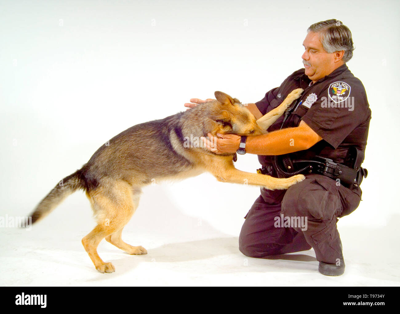An Amtrak railroad security policeman plays affectionately with his ...