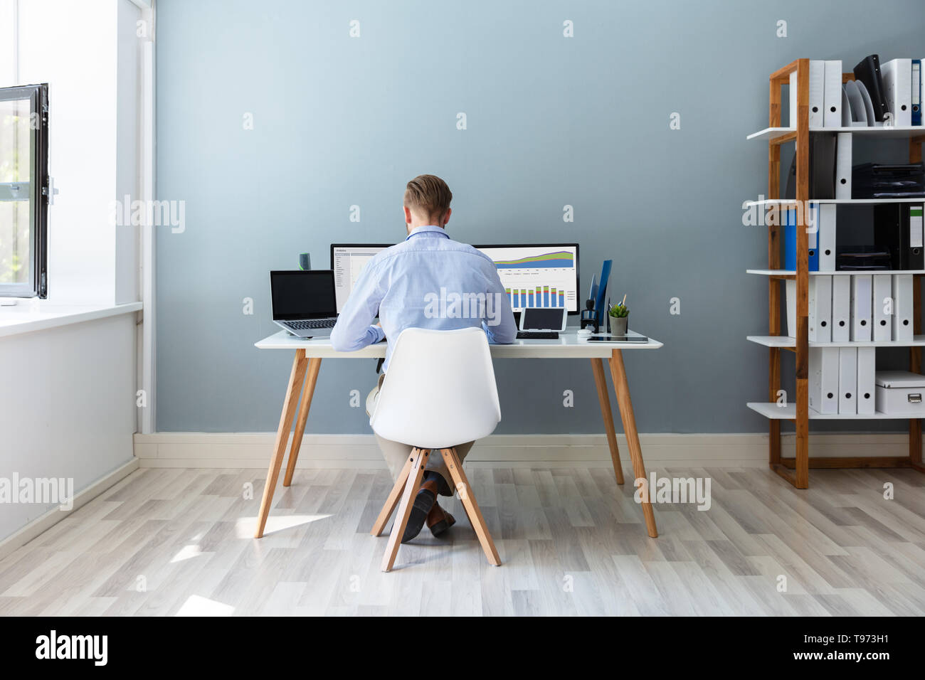 Rear View Of A Businessman Working On Desktop Computer In Office Stock ...