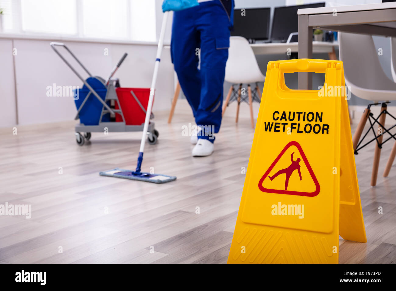 Male janitor with mop cleaning modern office floor Stock Photo - Alamy