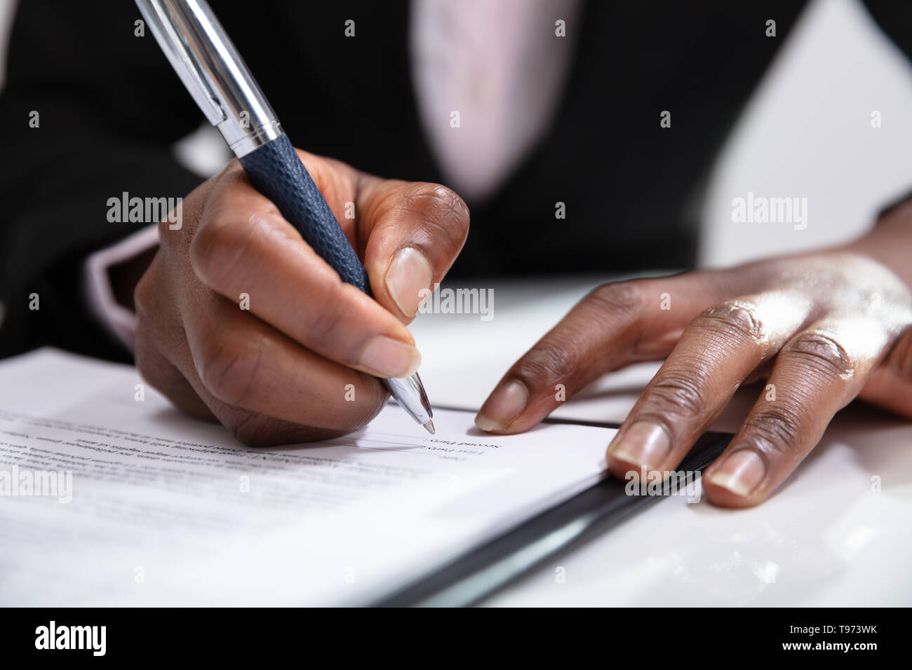 Female employee signing document in hi-res stock photography and images ...
