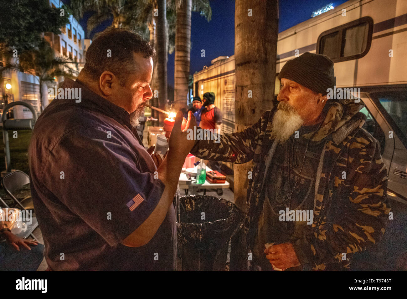 A bearded volunteer helps a released prisoner with food and support ...