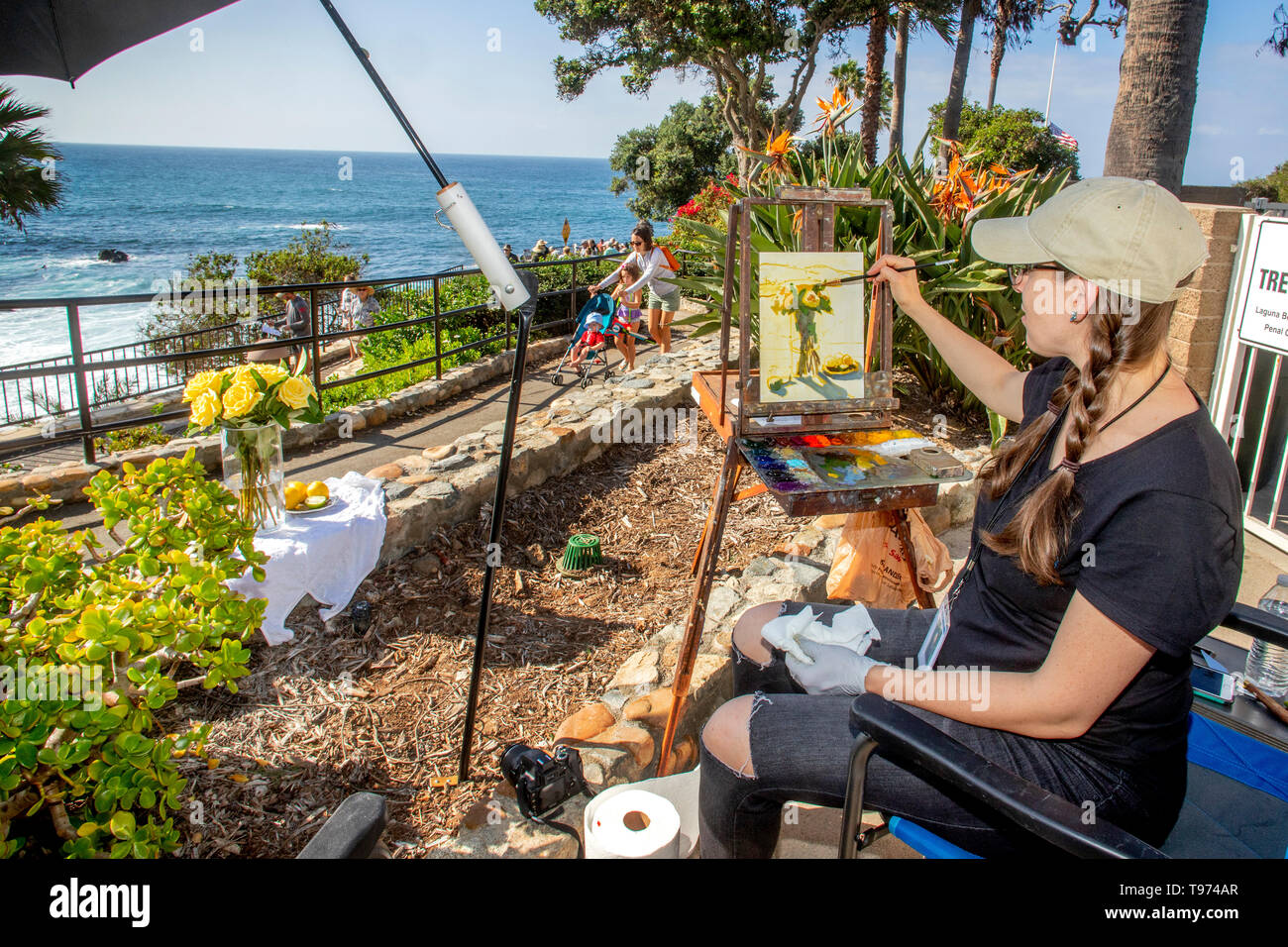 A scenic artist combines a vase of yellow roses and an ocean view into ...