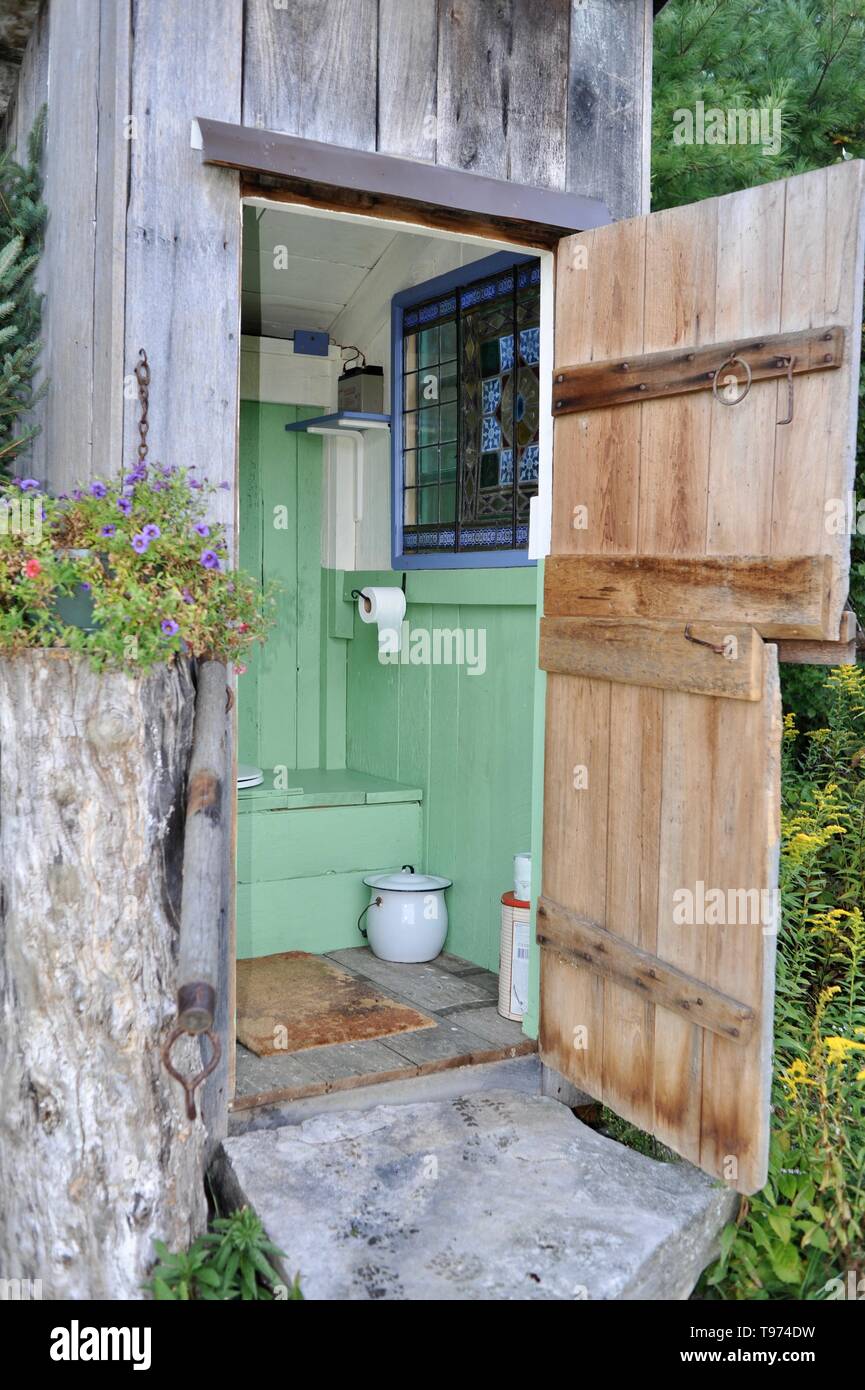Doors opened for outhouse or outside privy toilet for "glamping ...