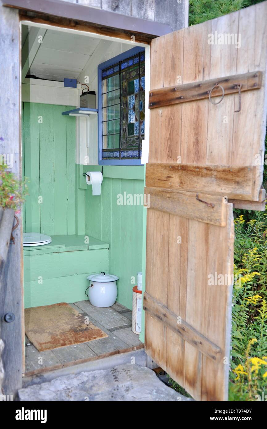 Doors opened for outhouse or outside privy toilet for "glamping ...