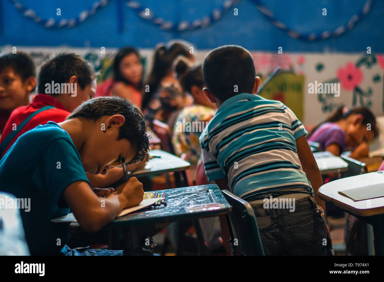 latin children writing in Guatemalan classroom Stock Photo - Alamy