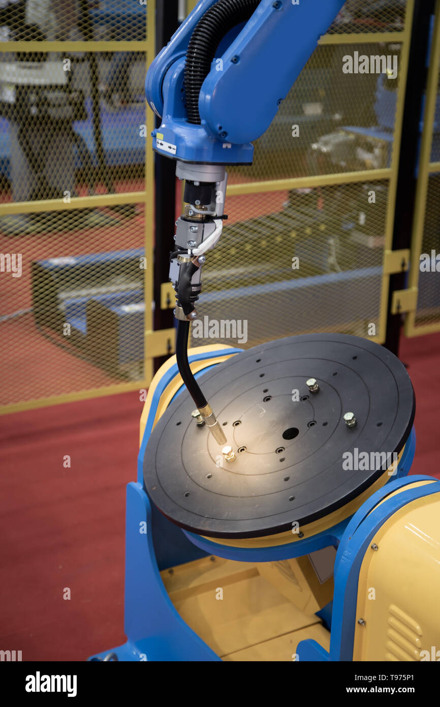 Closeup robotic welding arm with turning table Stock Photo - Alamy