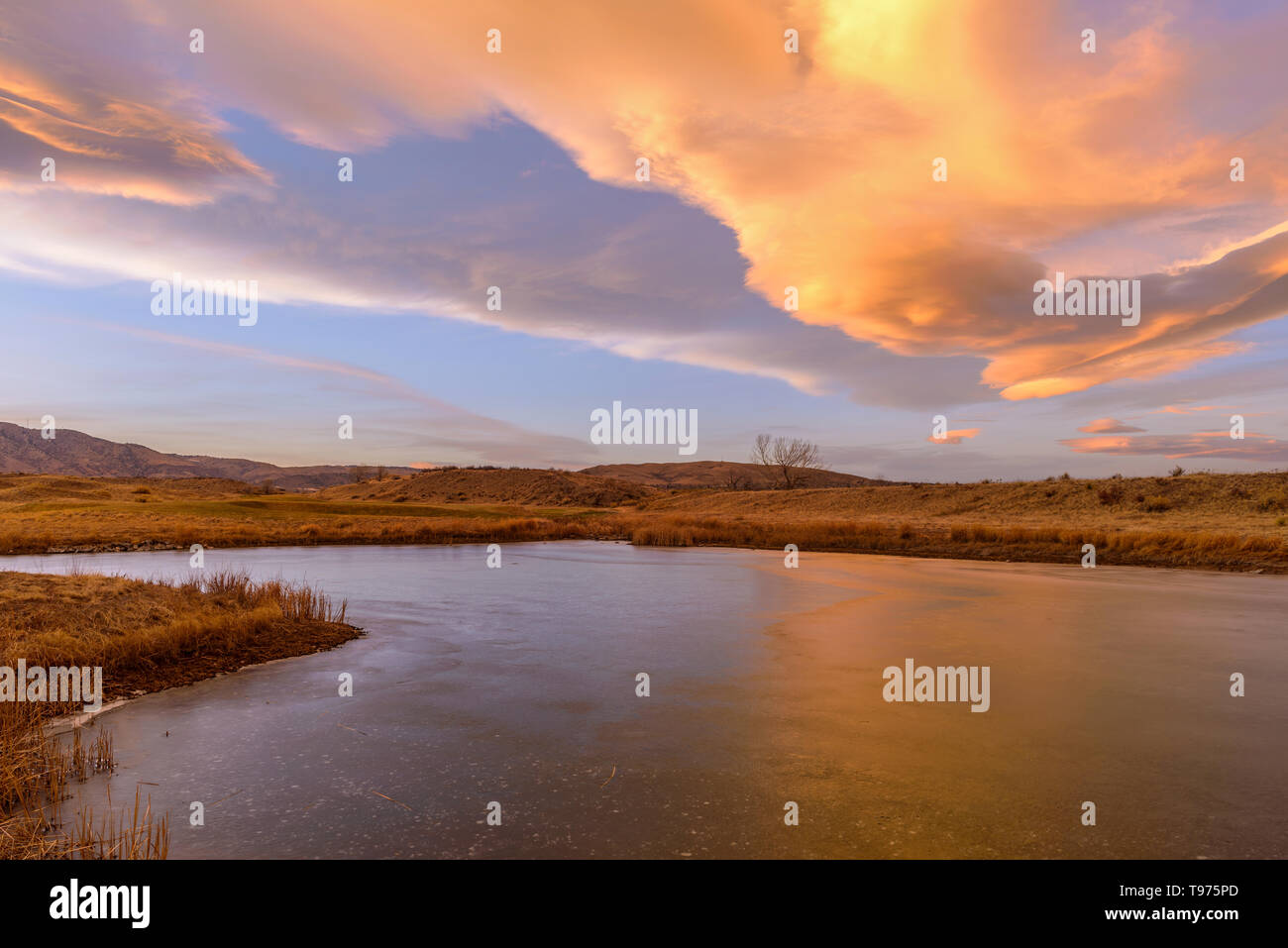 Winter Sunset Clouds - Colorful sunset clouds rolling over a frozen ...