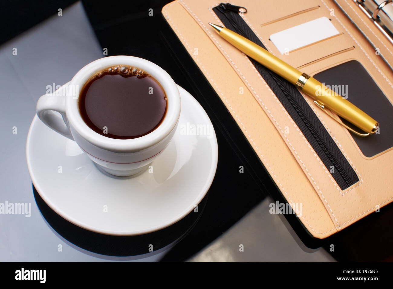 Cup of coffee with the diary on office desk Stock Photo - Alamy