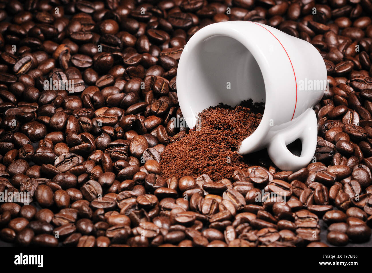 Cup with heap of coffee beans background Stock Photo - Alamy