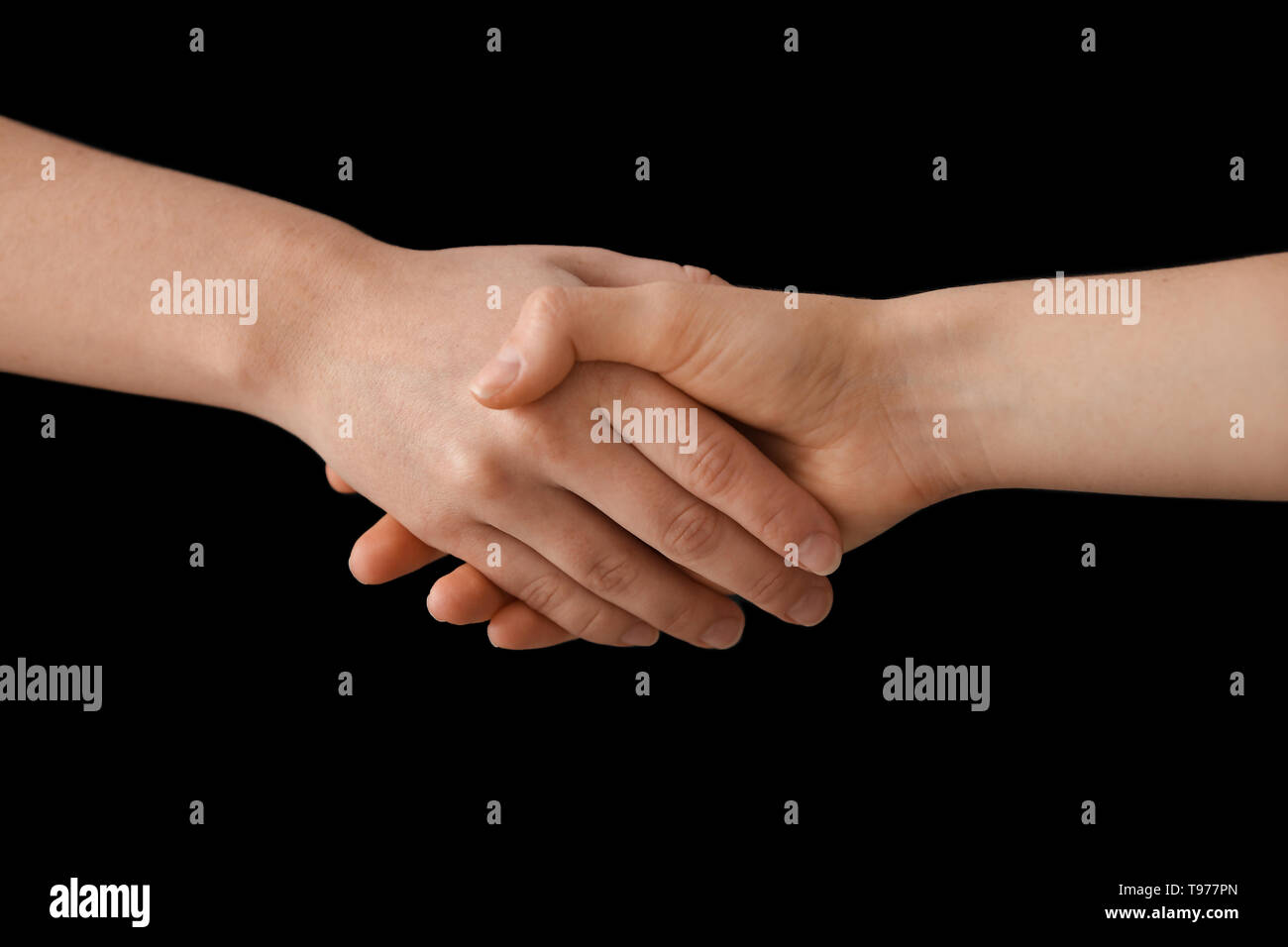 People shaking hands on dark background Stock Photo - Alamy
