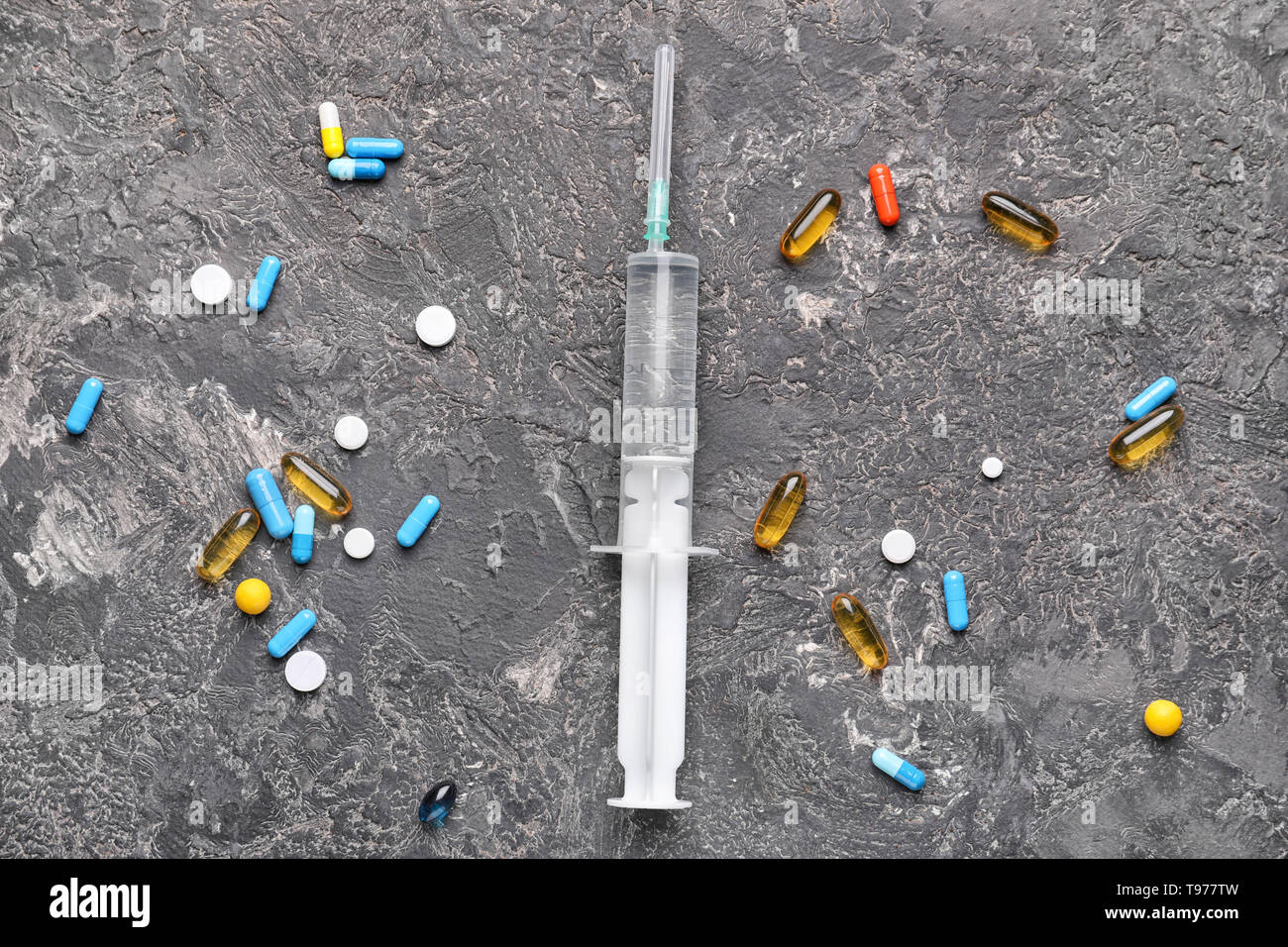 Syringe with drugs on grey background Stock Photo - Alamy