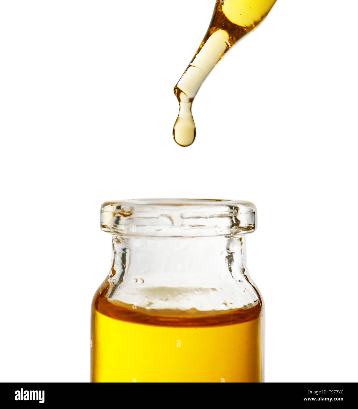 Dripping oil from pipette into glass bottle on white background Stock ...