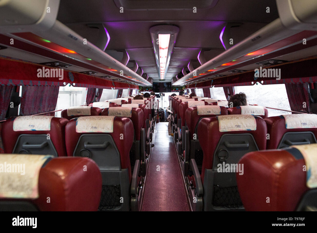 An interior of a tourist bus with maroon colour theme Stock Photo - Alamy