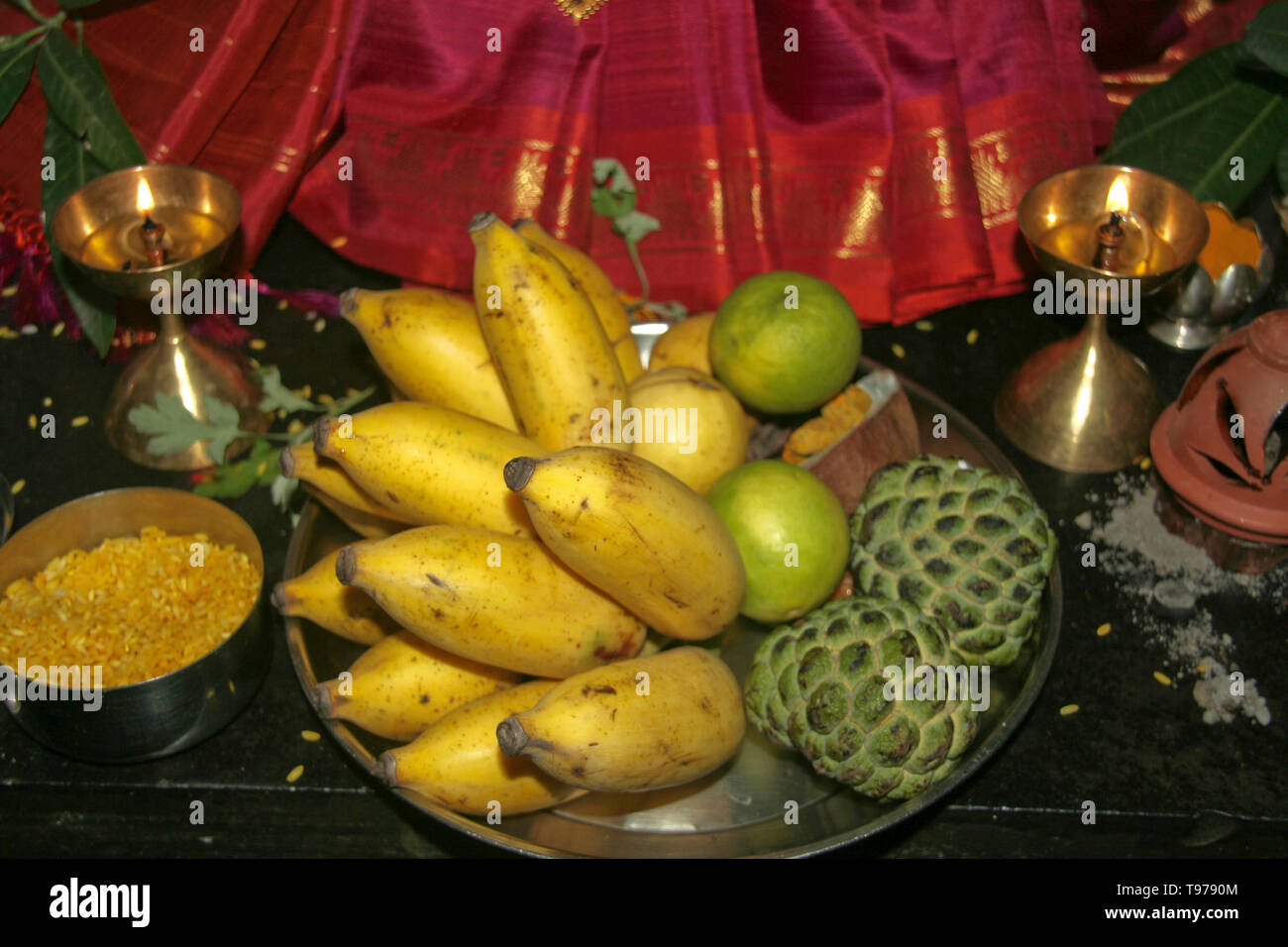 Bowl of fruits in setting of Puja (prayer to God Stock Photo - Alamy