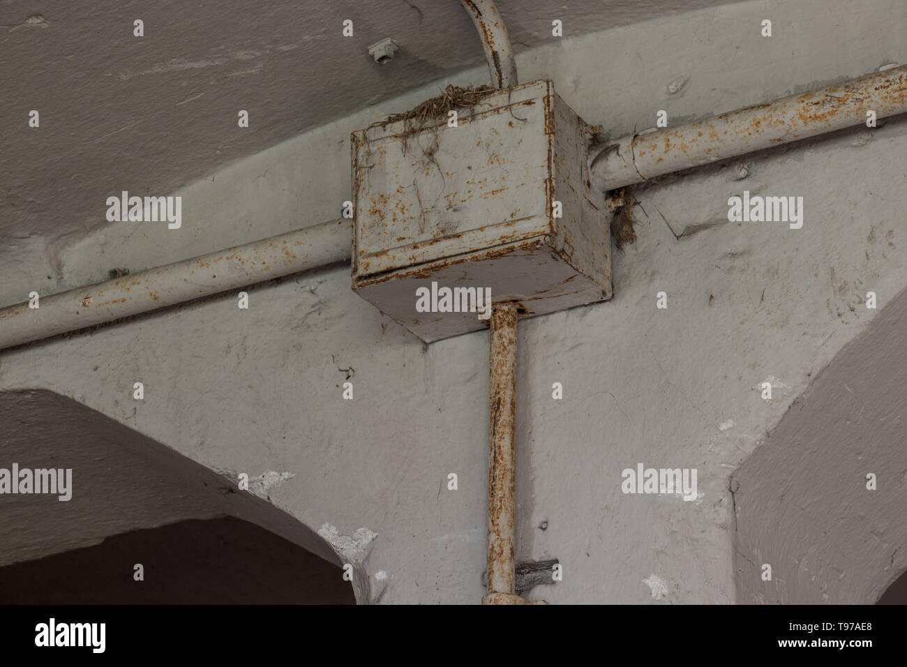 old electrical boxes on wall with 3 pipes Stock Photo - Alamy