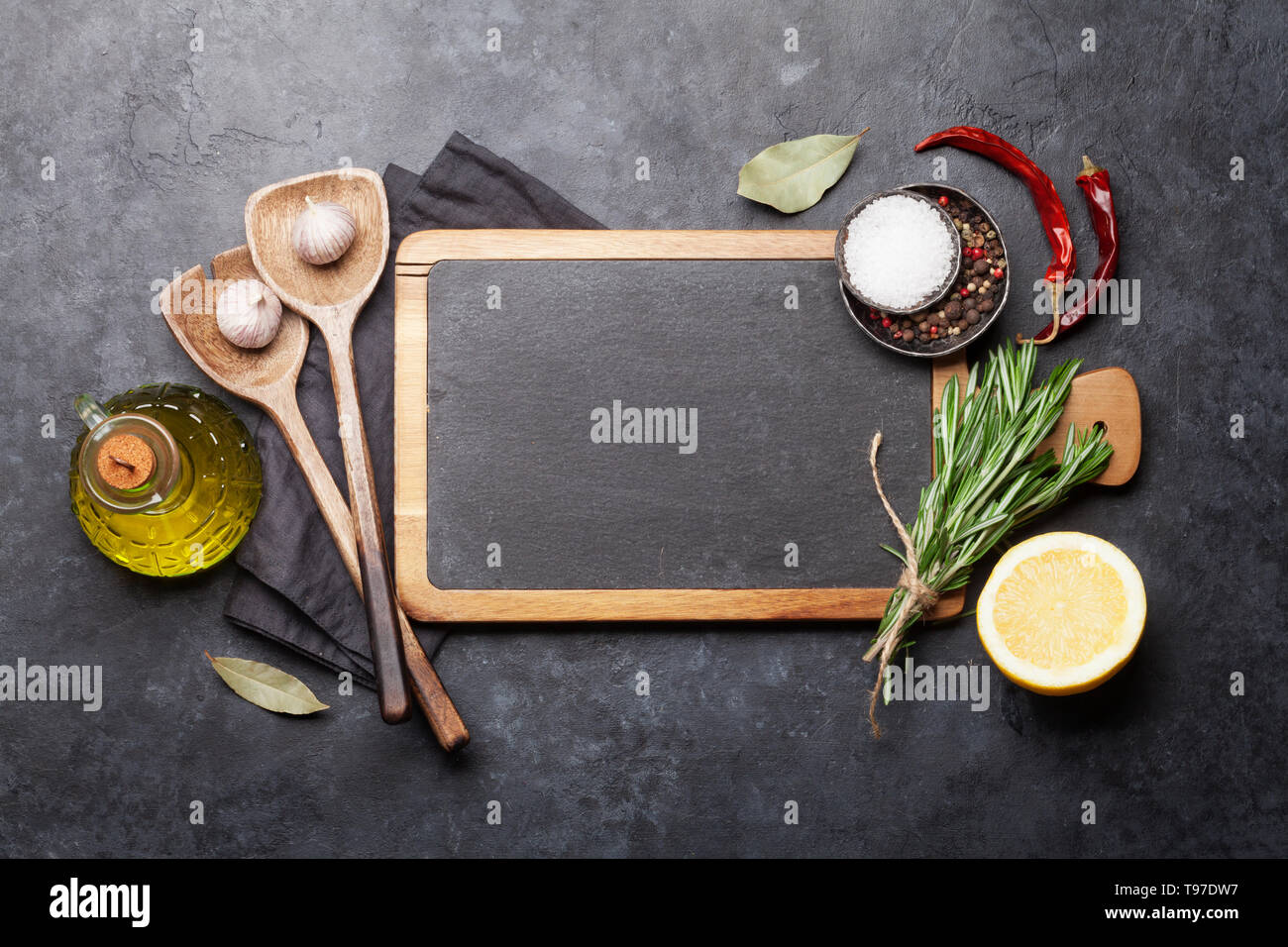 Cooking ingredients and utensils on stone table. Top view with ...