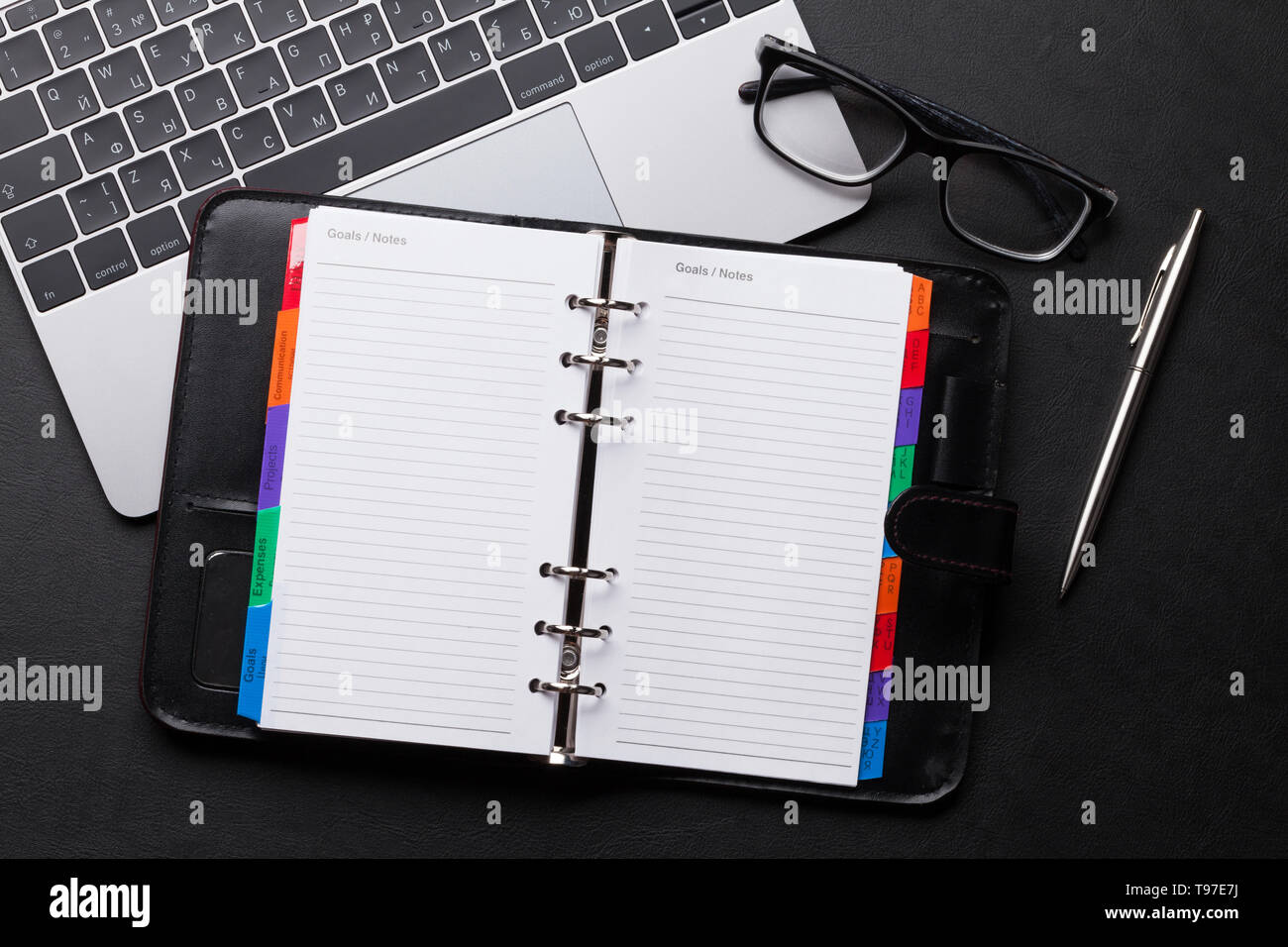 Office workplace table with notepad and laptop. Flat lay. Top view with ...