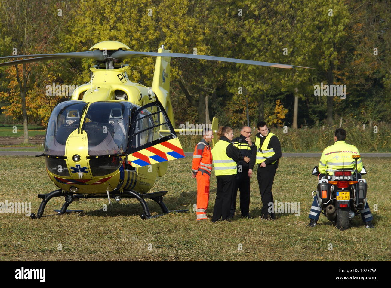 Dutch Ambulance Helicopter (Lifeliner 1) stands on grass in Almere Stad ...