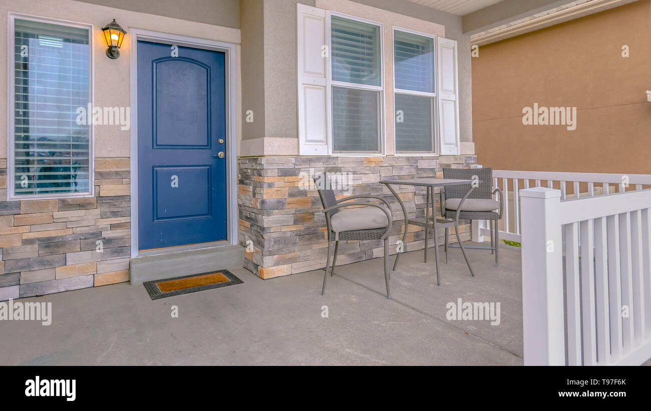 Clear Panorama Home exterior with a blue front door and reflective ...
