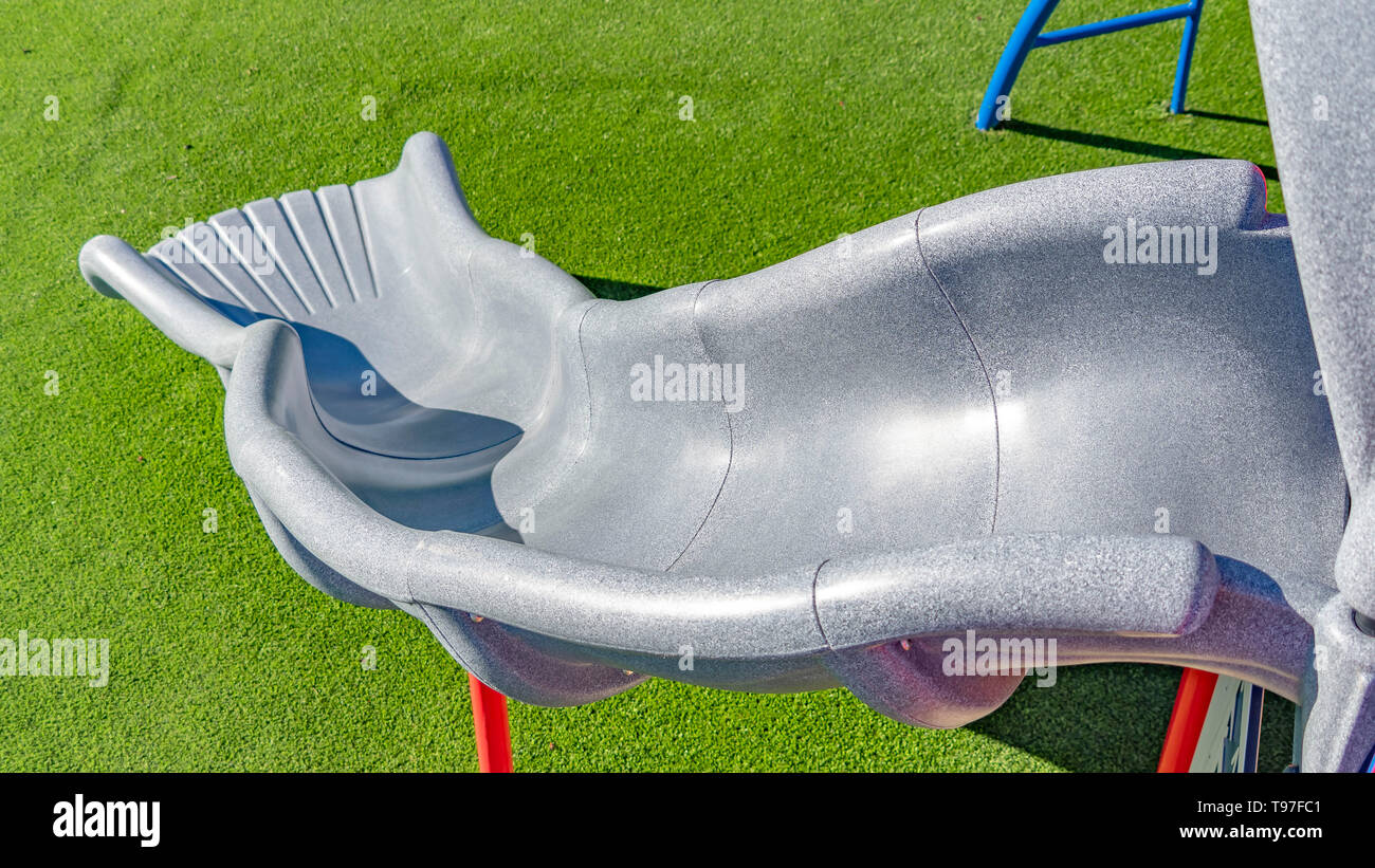 Clear Panorama Shiny gray slide of a playground viewed against a ...