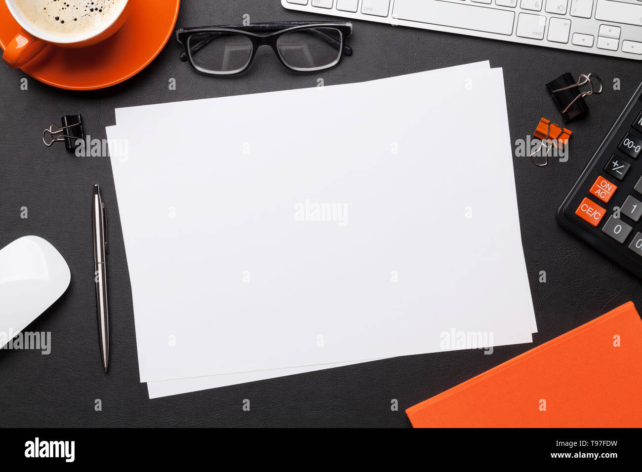 Office workplace table with blank paper page, coffee cup, supplies and ...