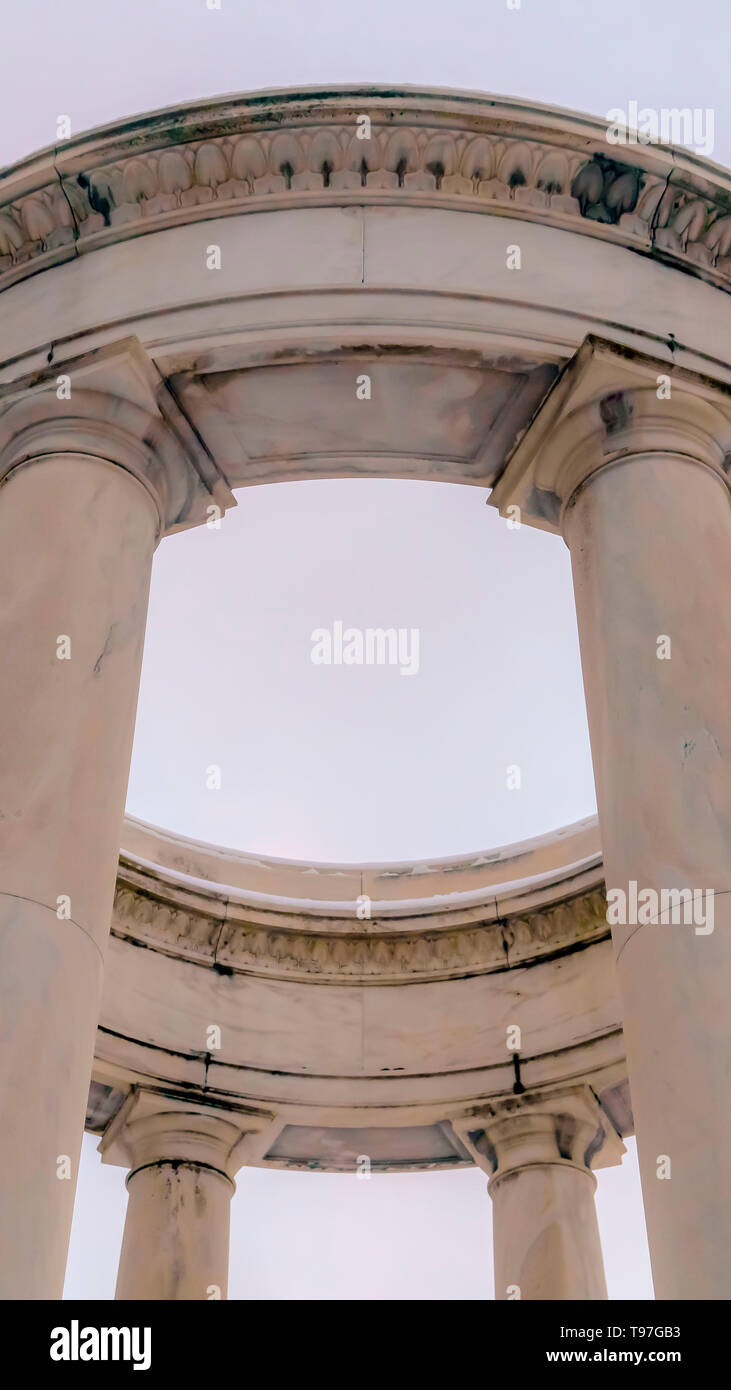 Clear Vertical Looking up at a white circular structure supported by ...