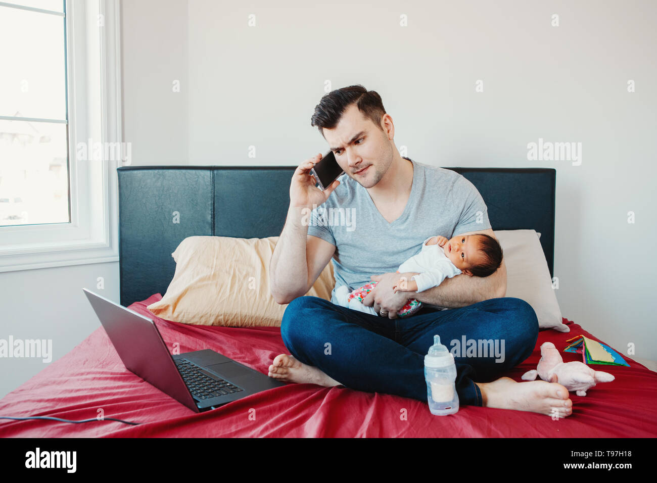 Caucasian father dad with newborn mixed race Asian Chinese baby working ...