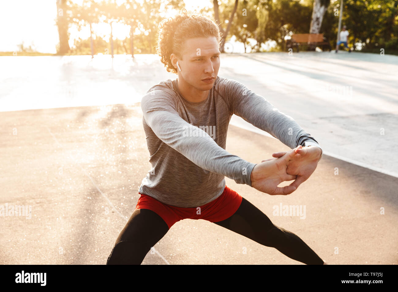 Healthy young sportsman doing exercises outdoors Stock Photo - Alamy