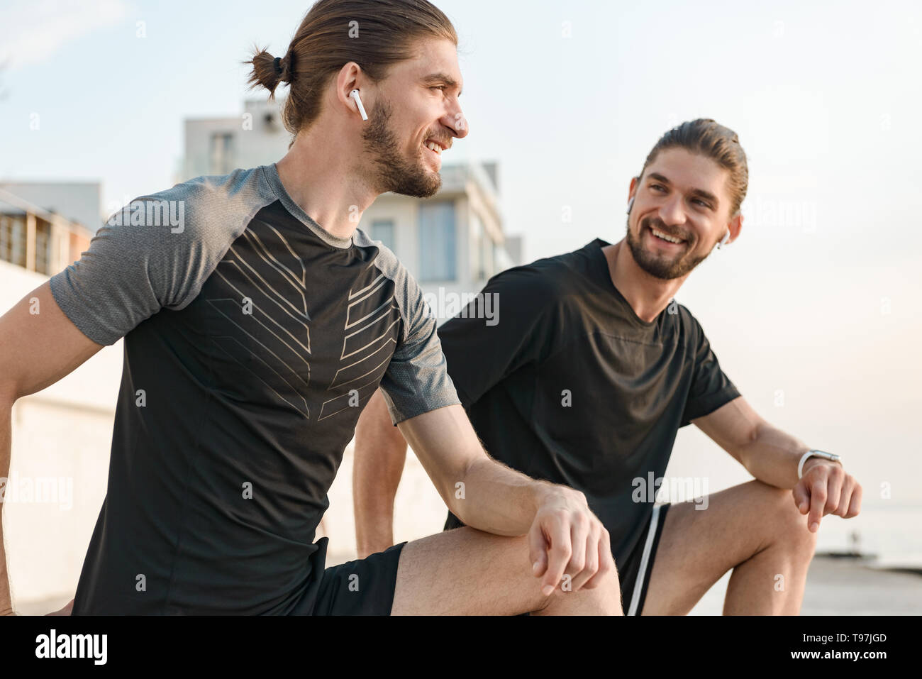 Two twin brothers doing exercises at the beach together Stock Photo - Alamy