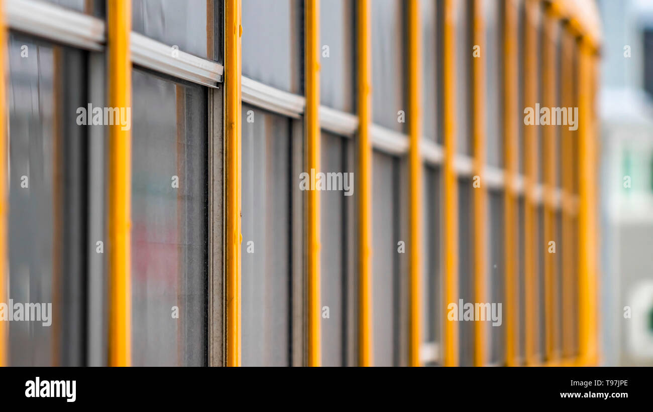 Panorama Exterior view of a yellow school bus with a close up on the ...