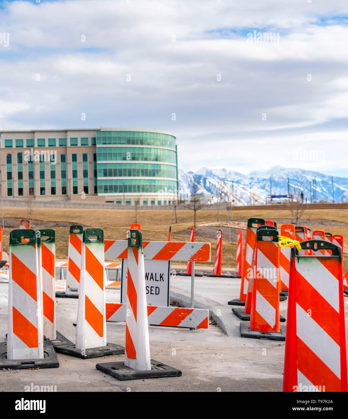Vertical Sidewalk Closed sign and road safety poles on a paved road ...