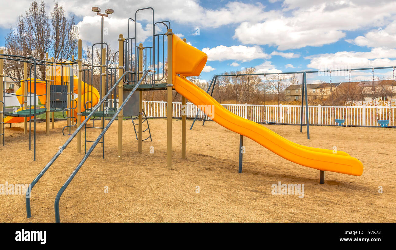 Panorama Playground with slides and swings under the blue sky filled ...