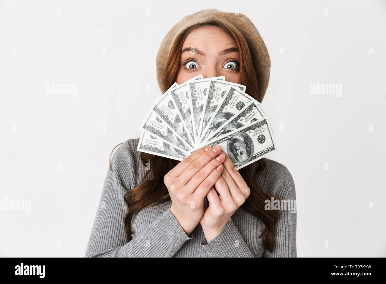 Image of shocked beautiful woman holding money isolated over white wall ...