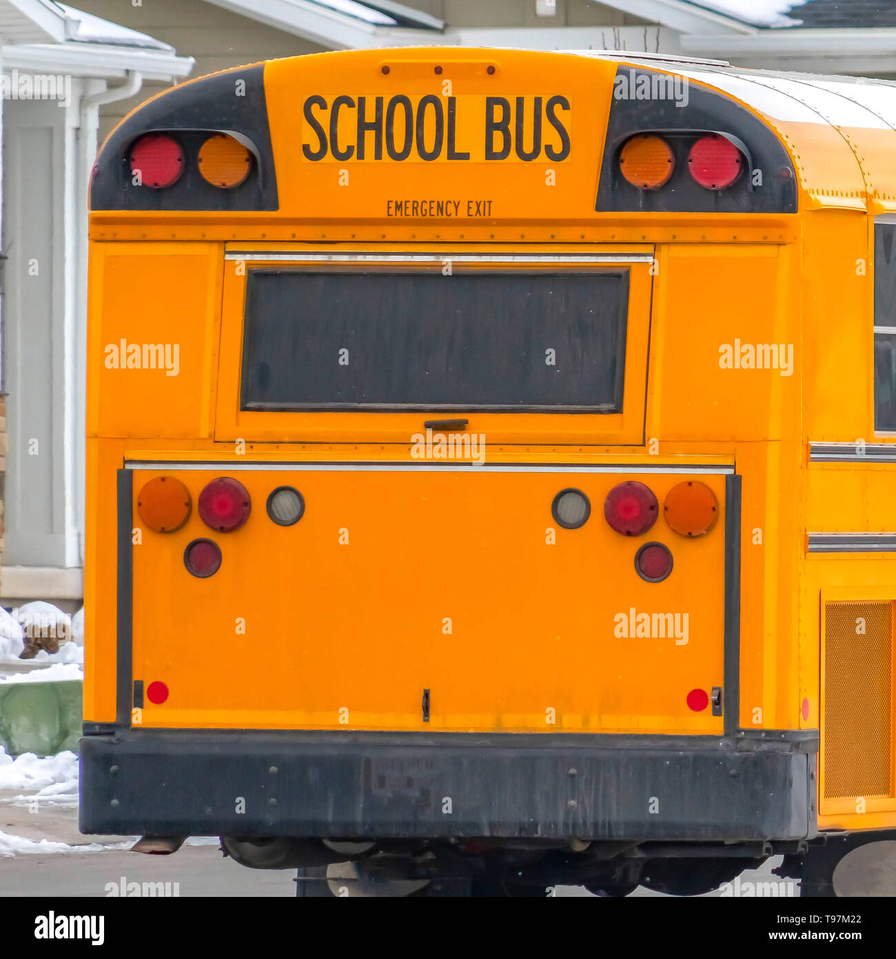 Clear Square Rear view of a yellow school bus running on a road with ...
