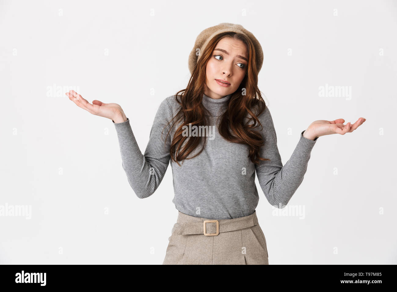 Portrait of discontent woman 30s wearing hat shrugging and throwing up ...