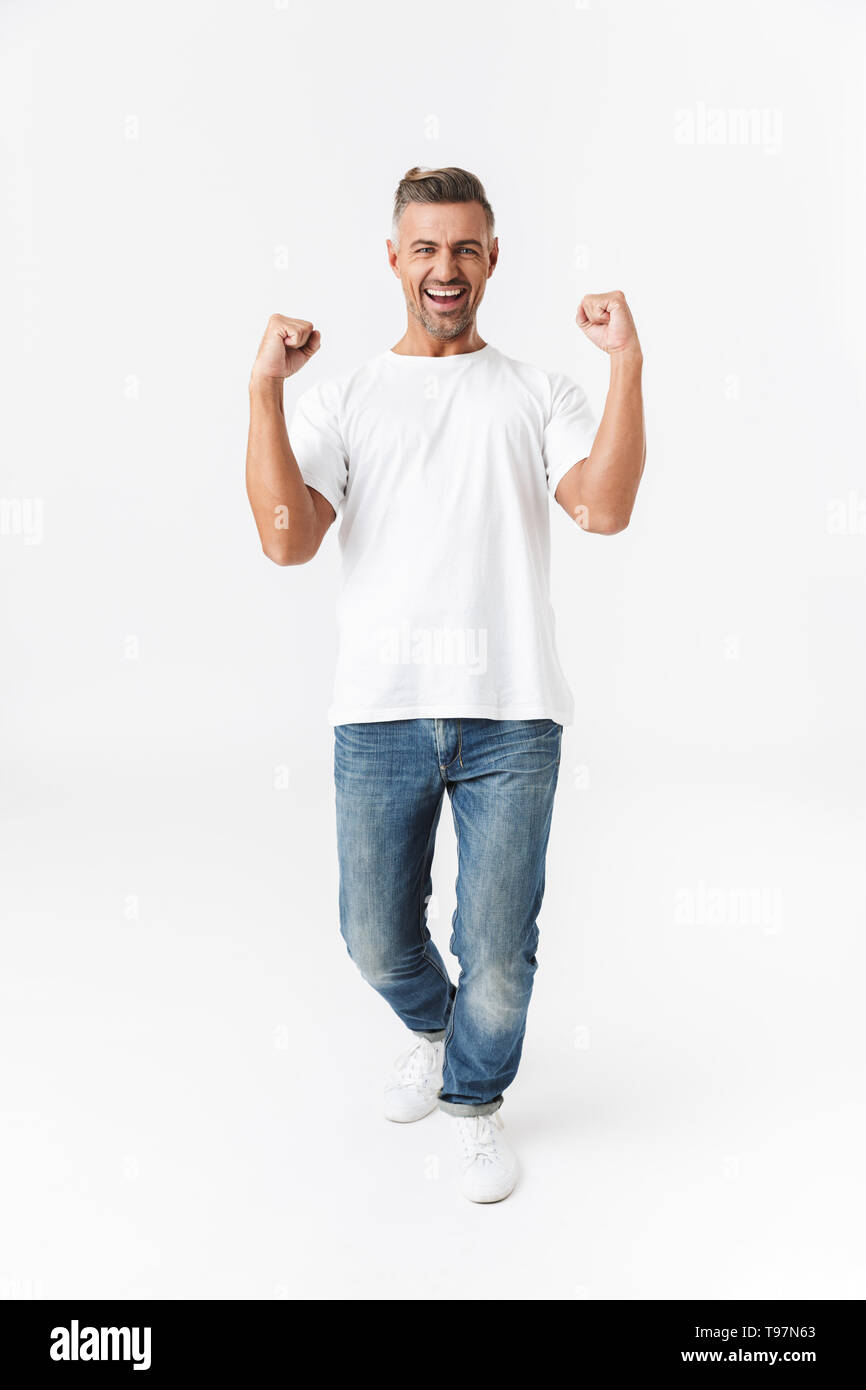 Full length portrait of a handsome casual man standing isolated over ...