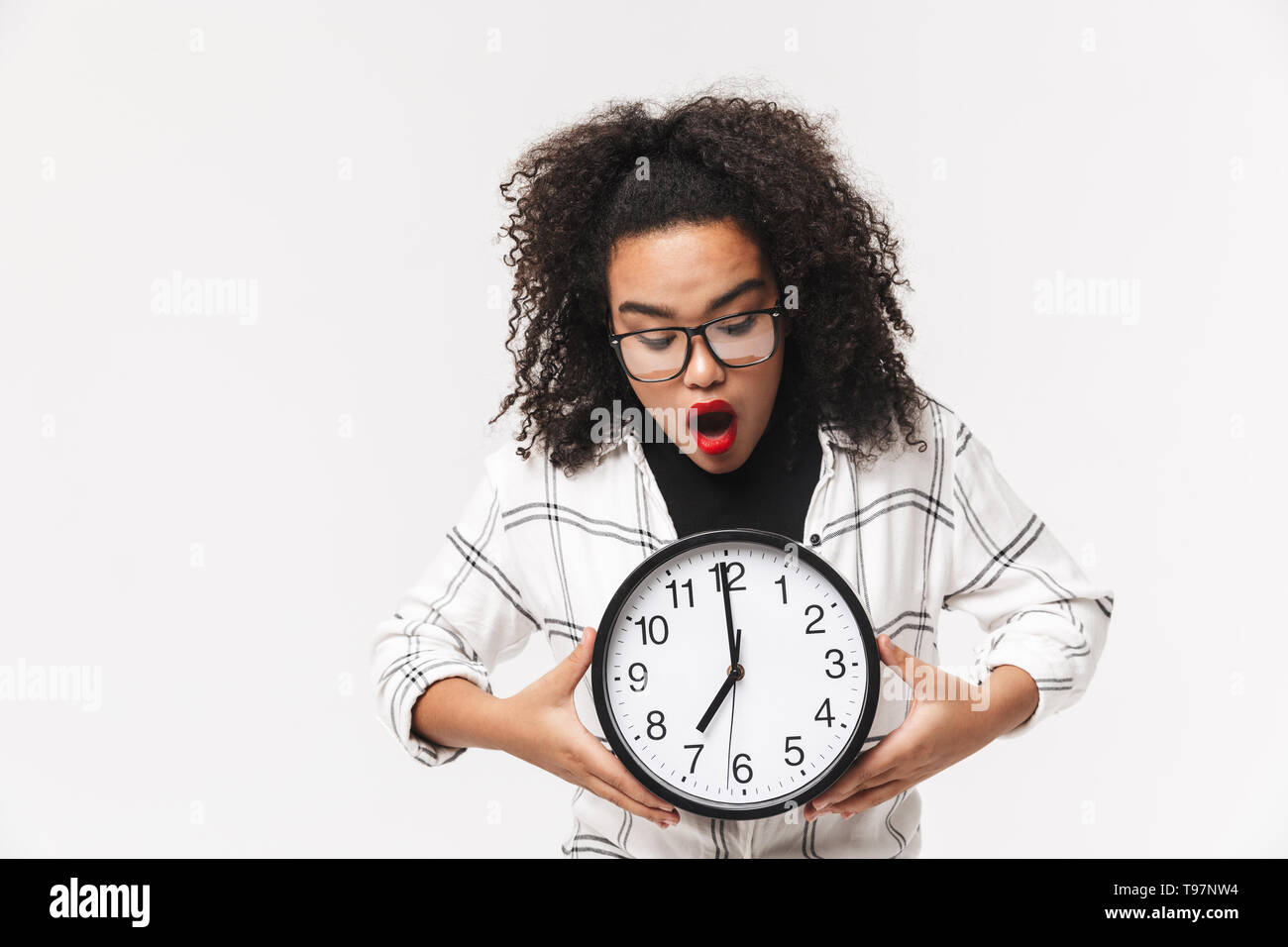 Portrait of a confused african woman standing isolated over white ...