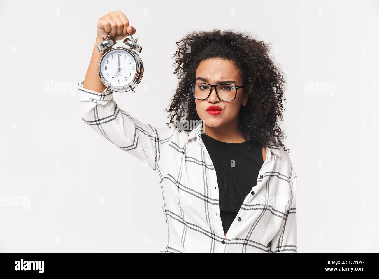 Portrait of a shocked confused african woman standing isolated over ...