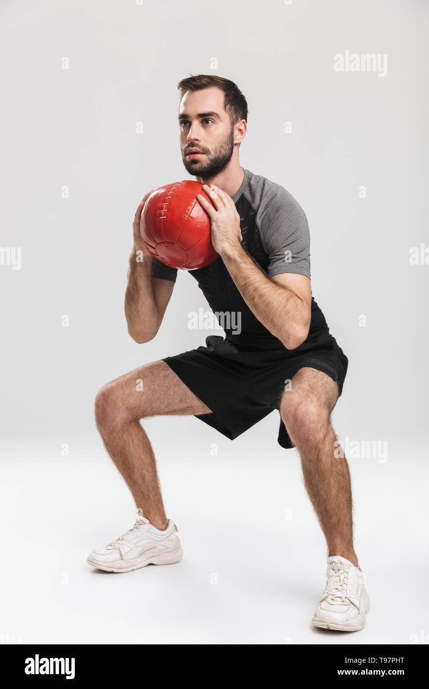 Image of a handsome young sports fitness man posing isolate over white ...