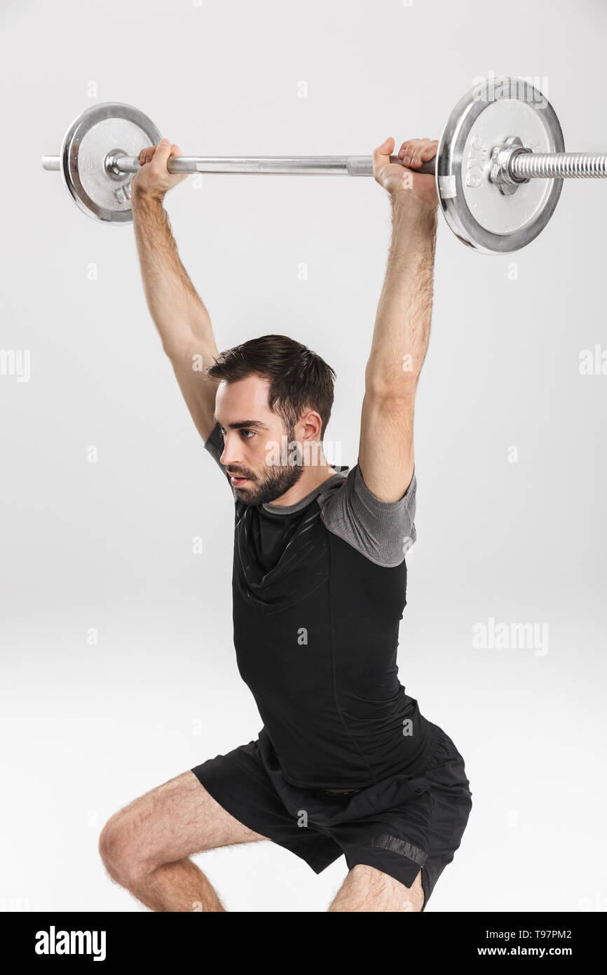 Image of a young sports fitness man isolate over white wall background ...