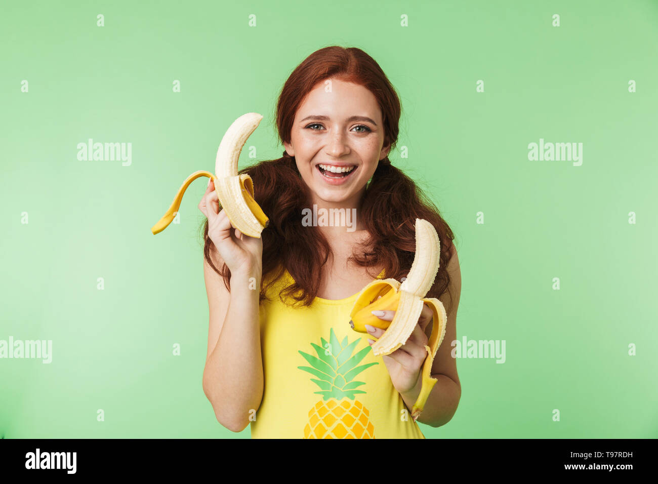 Image of a beautiful excited young redhead girl posing isolated over ...