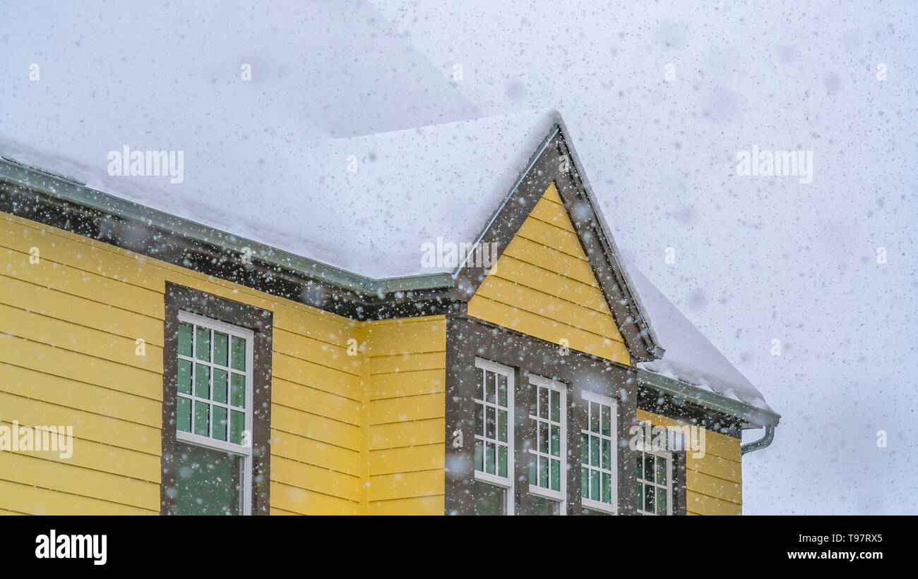 Clear Panorama Snow falling on a yellow home in Daybreak Utah Stock ...
