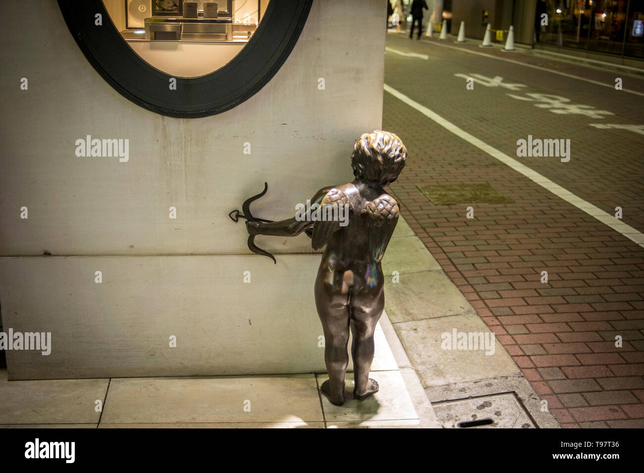 Statue of Cupid hiding behind a corner on Ginza street in Tokyo Stock ...